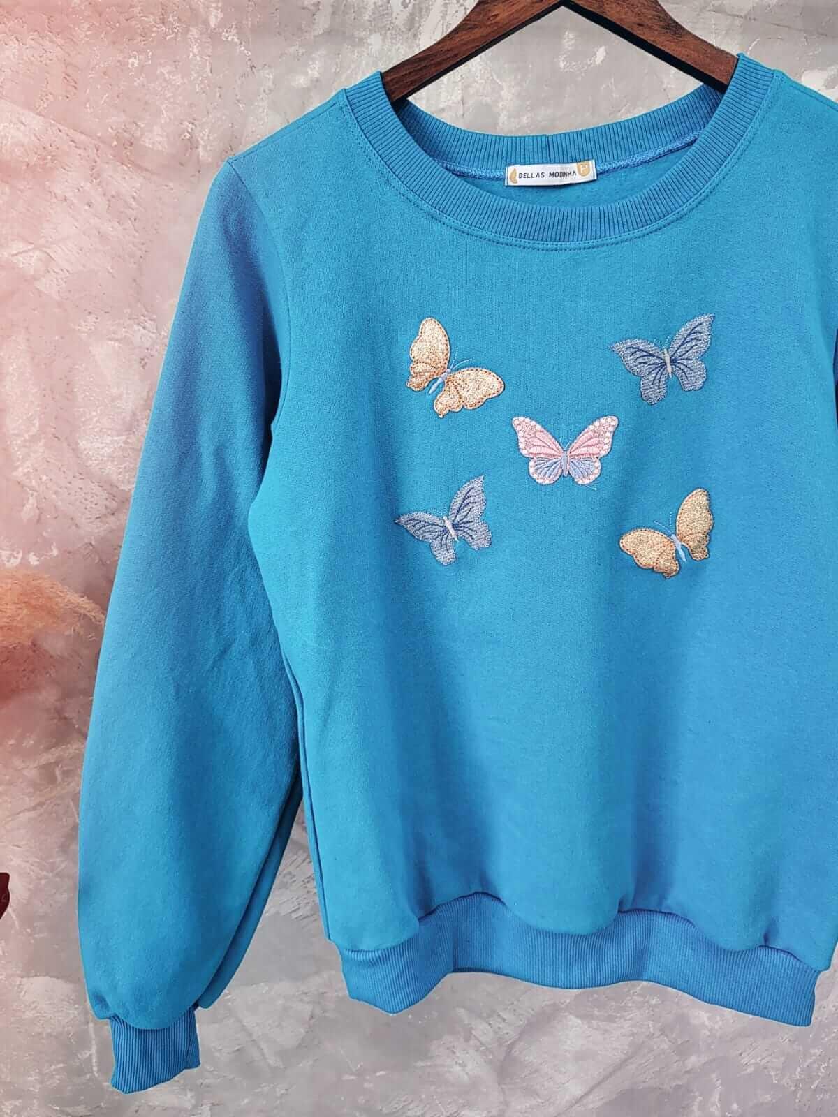 MOLETOM FEMININO PELUCIADO BORDADO BORBOLETAS AZUL - a partir de R$89,19